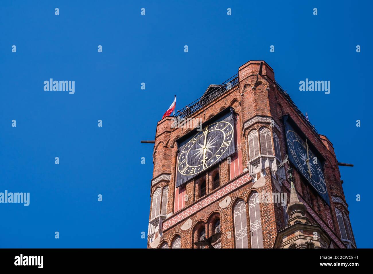 Low angle shot of the Clock Tower of Ratusz building in Torun, Poland ...