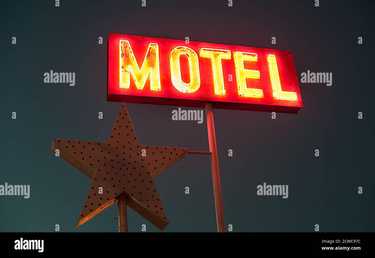 vintage old motel sign glowing in the night sky, vibrant vintage ...