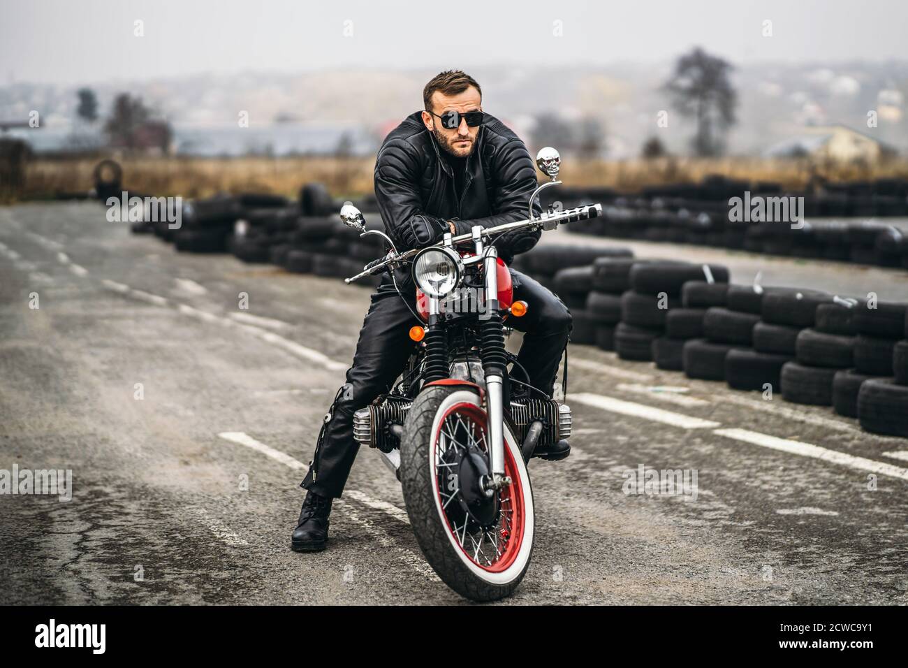 Bearded man in sunglasses and leather jacket looking at the camera ...