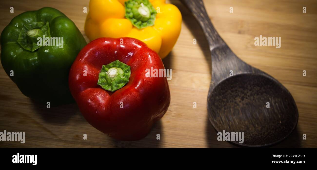 Colorful capsicum on wooden table background Stock Photo - Alamy