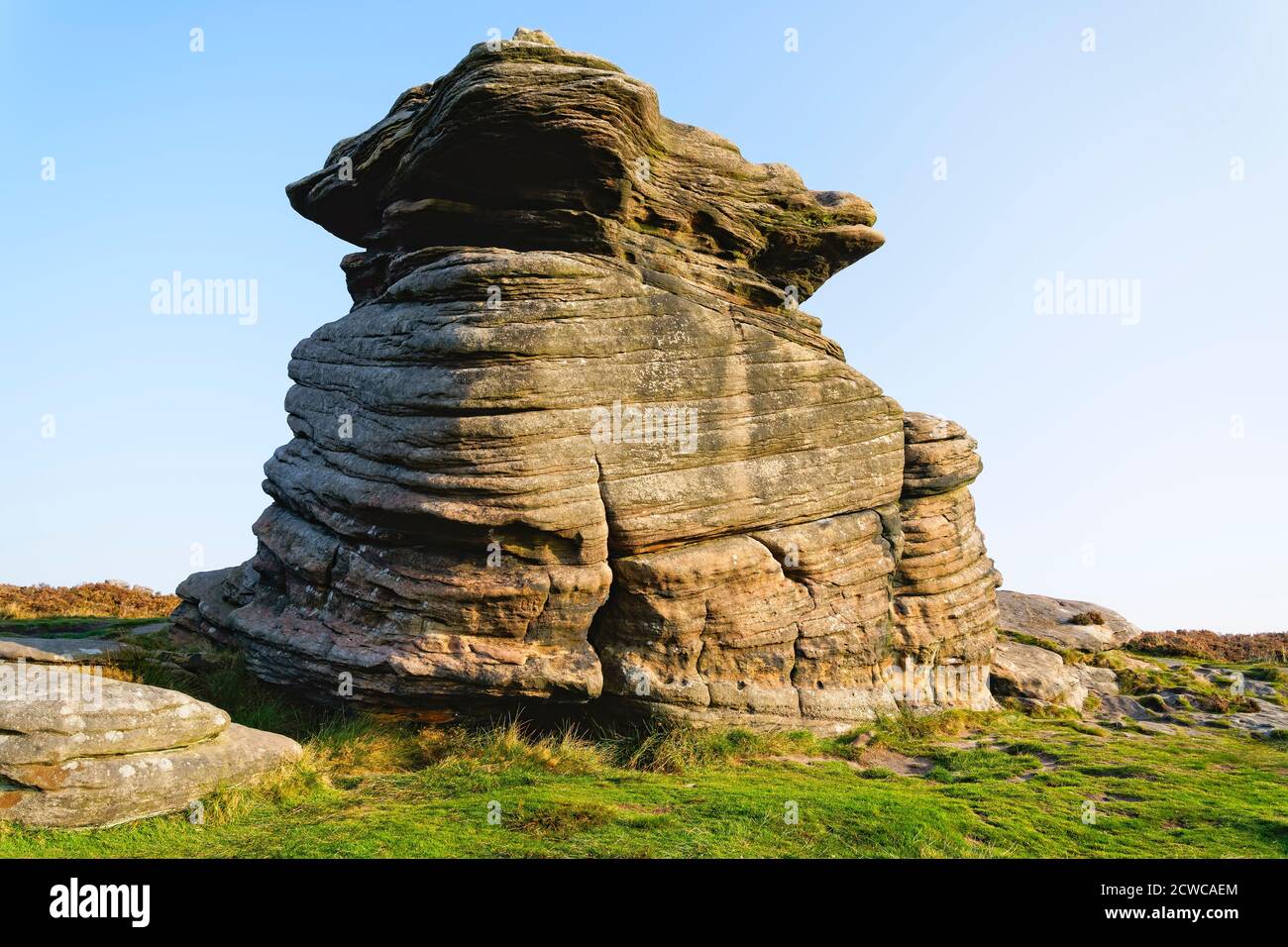 Early morning autumn sunlight lights up the Mother Cap rock formation ...