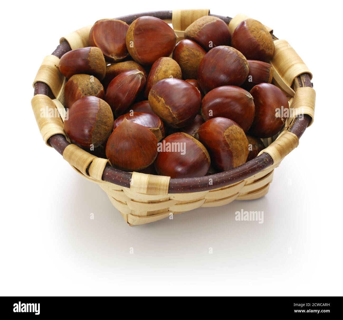 chestnuts in the basque chestnut basket isolatd on white background ...