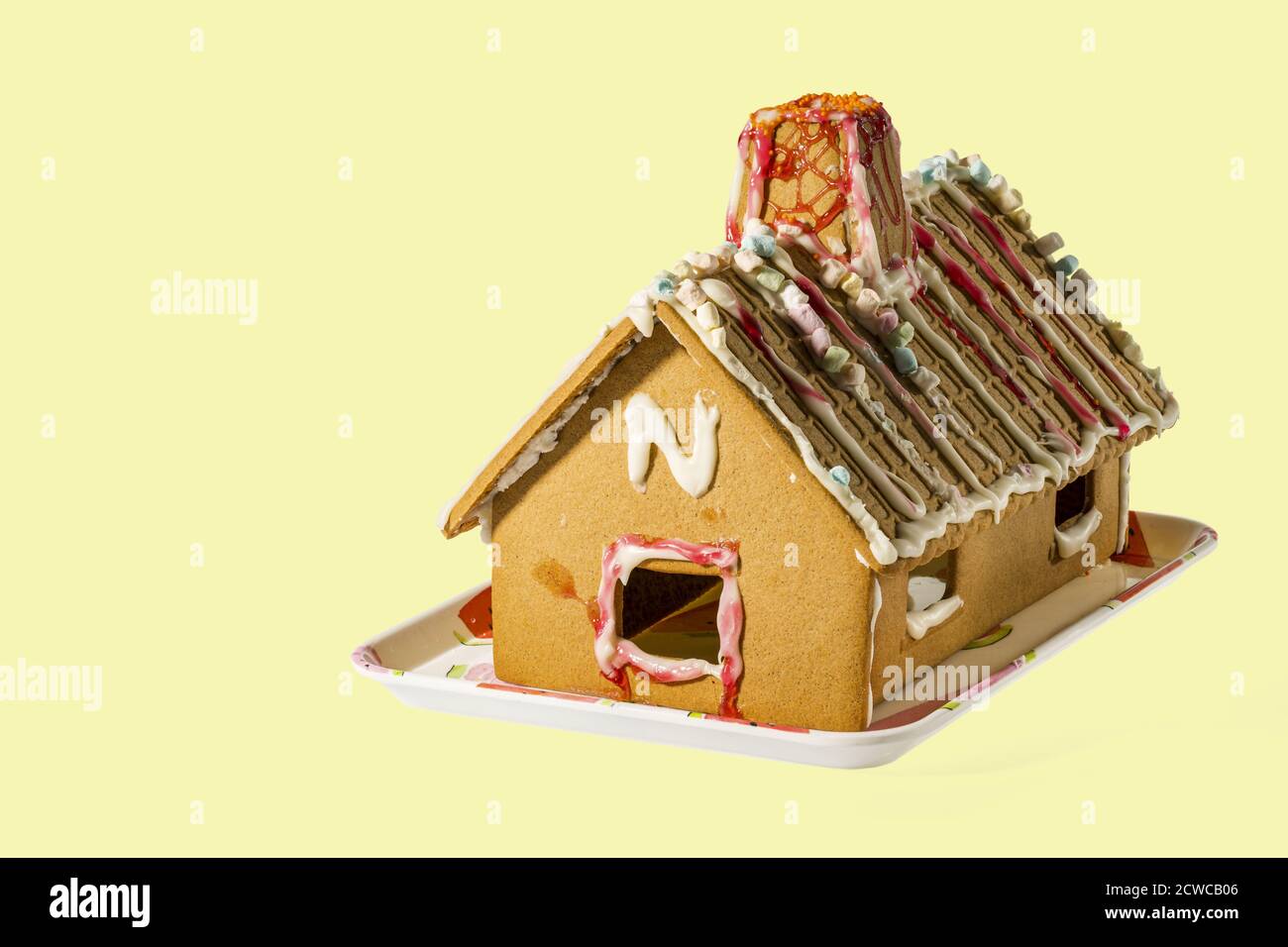 Close up view of gingerbread house on yellow background. Holidays and ...
