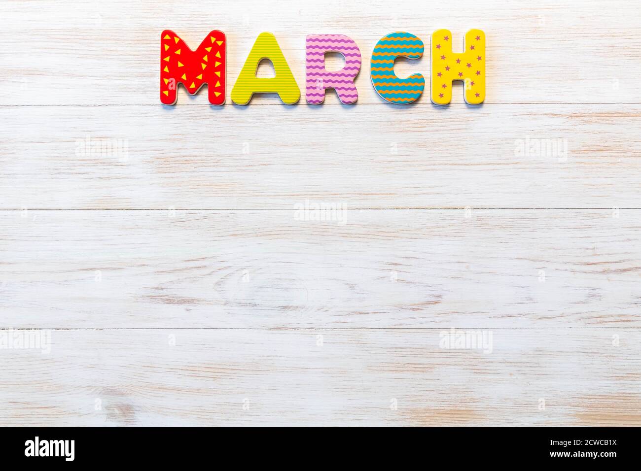 Wooden letters written March month on vintage background. Inscription ...