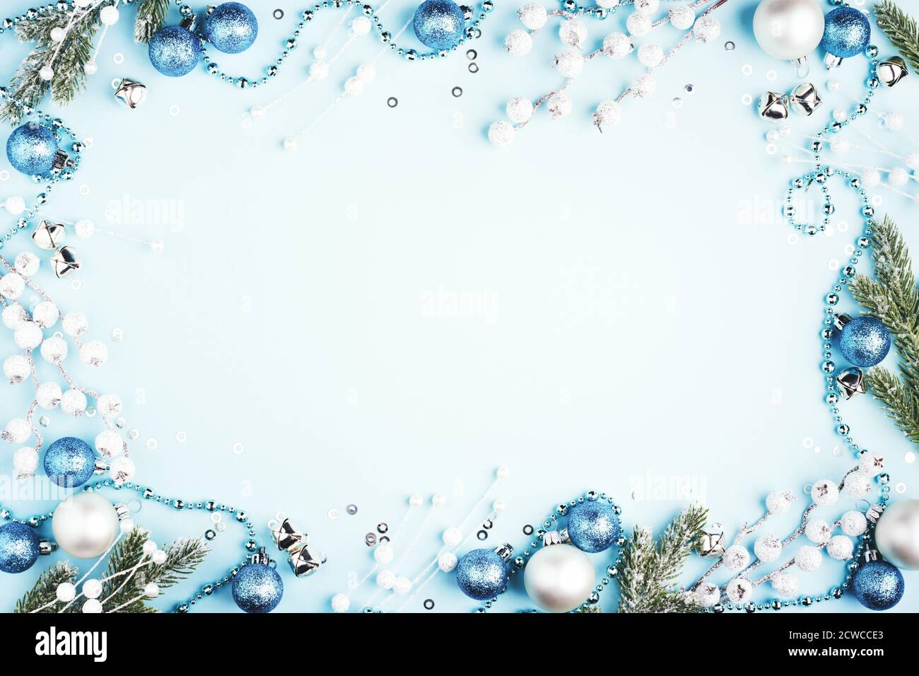 Christmas frame with fir branches, baubles and decorations on blue ... Christmas frame with fir branches, baubles and decorations on blue ...