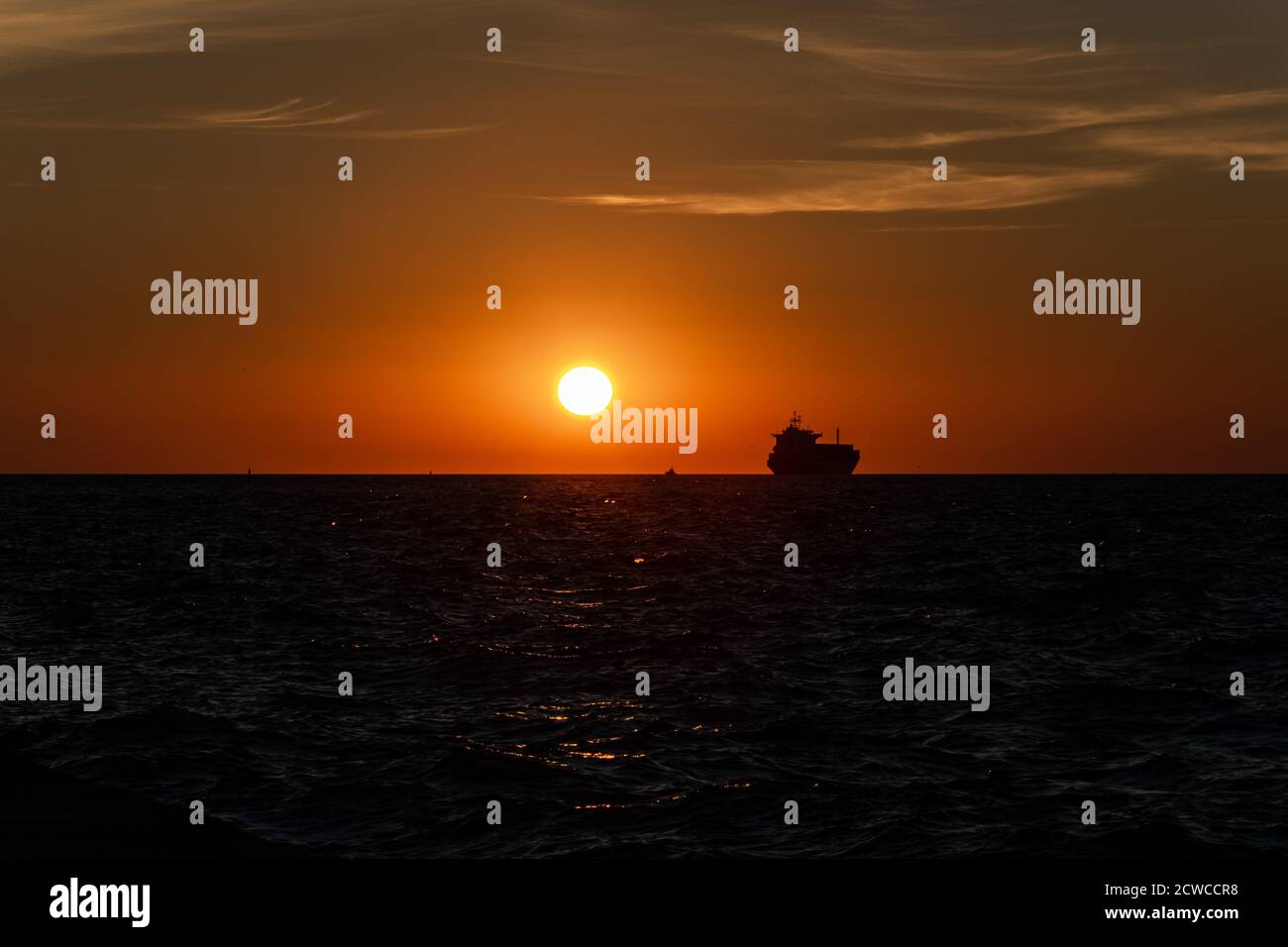 The silhouette of the ship on the horizon, going into the sunset Stock Photo - Alamy