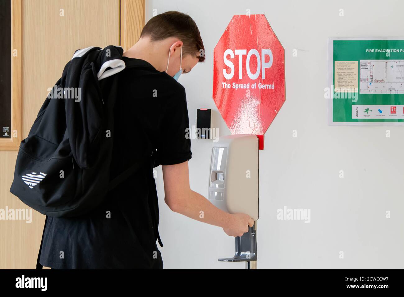 Young boy hand under automatic foam dispenser before go inside. in soft ...
