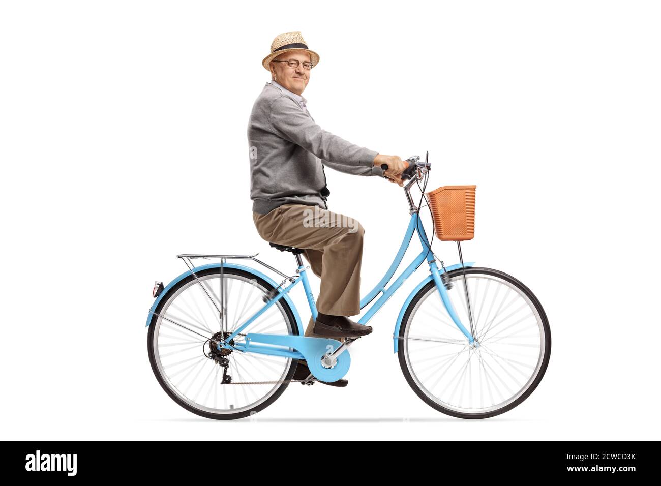 Elderly man riding a blue bicycle and smiling at camera isolated on ...