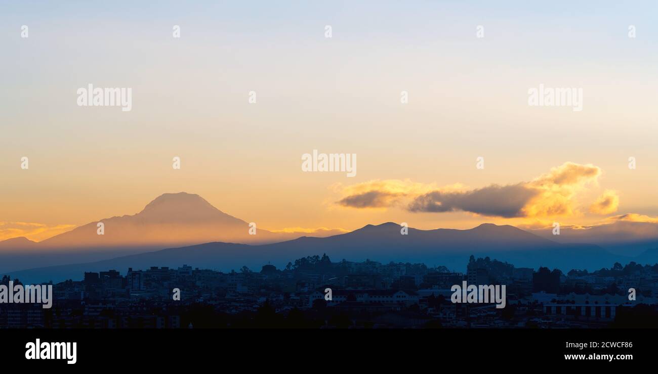 Sun rays illuminating the Cayambe volcano at sunrise, Quito, Ecuador ...