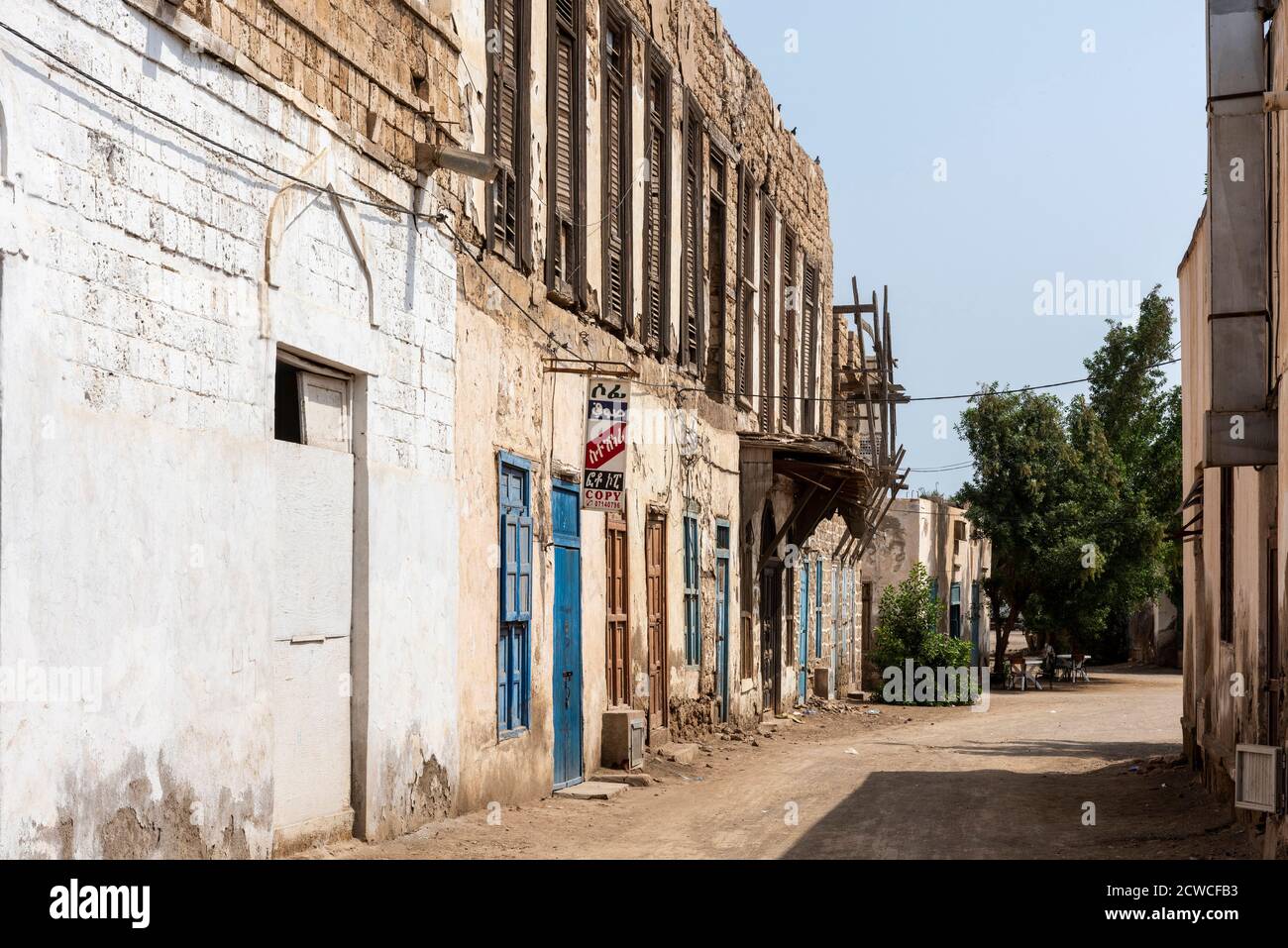 Street scene in Massawa. Some of the buildings built with coral have ...