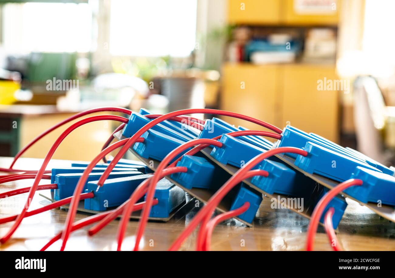 Close-up of a large green microcircuit with red HI-voltage wires and ...