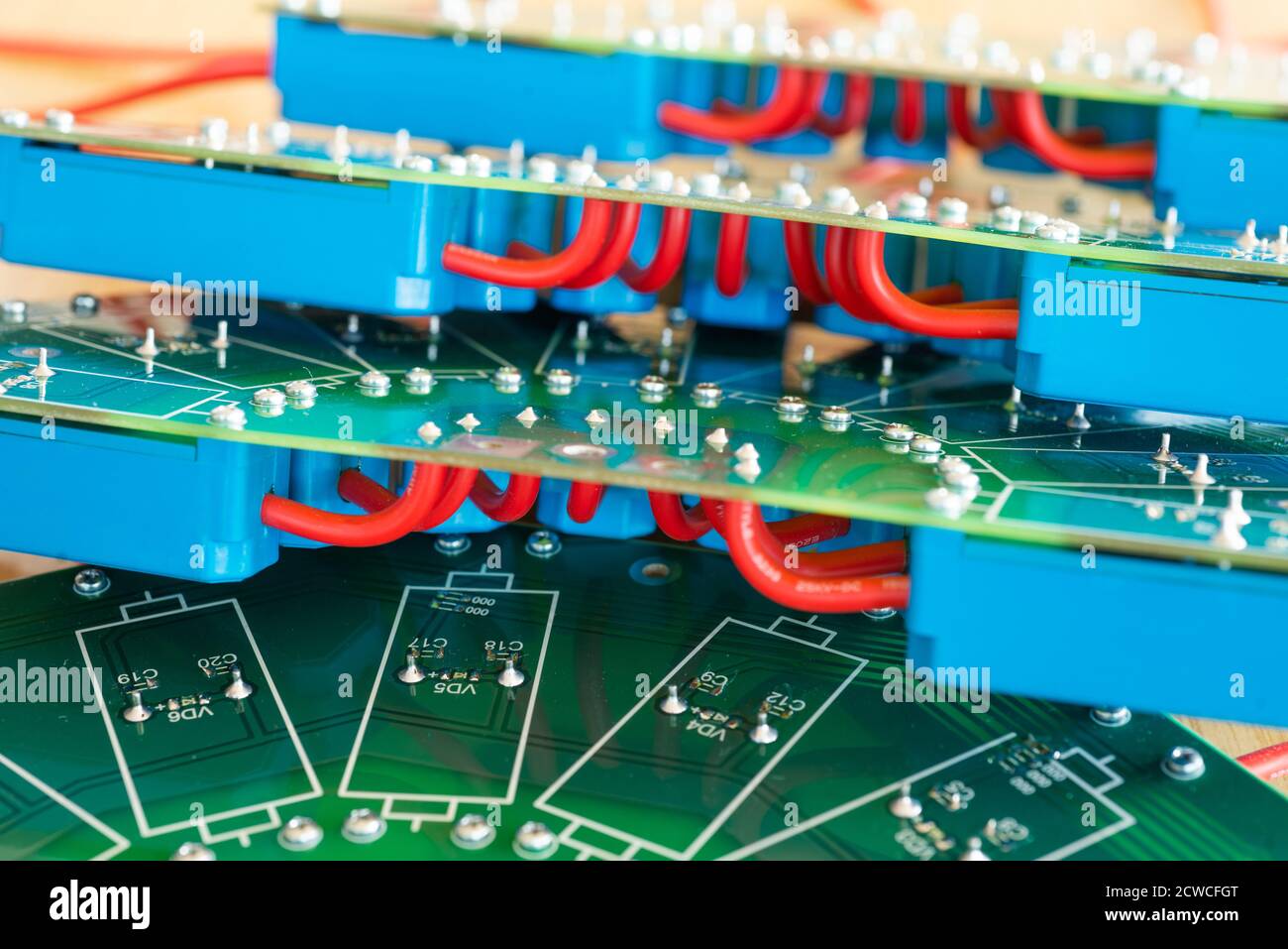 Close-up of a large green microcircuit with red HI-voltage wires and ...