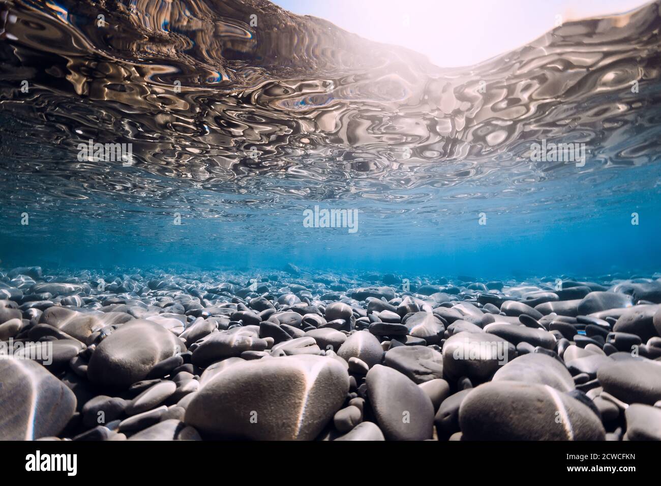 Underwater view with stones, reflection and blue sea water Stock Photo ...