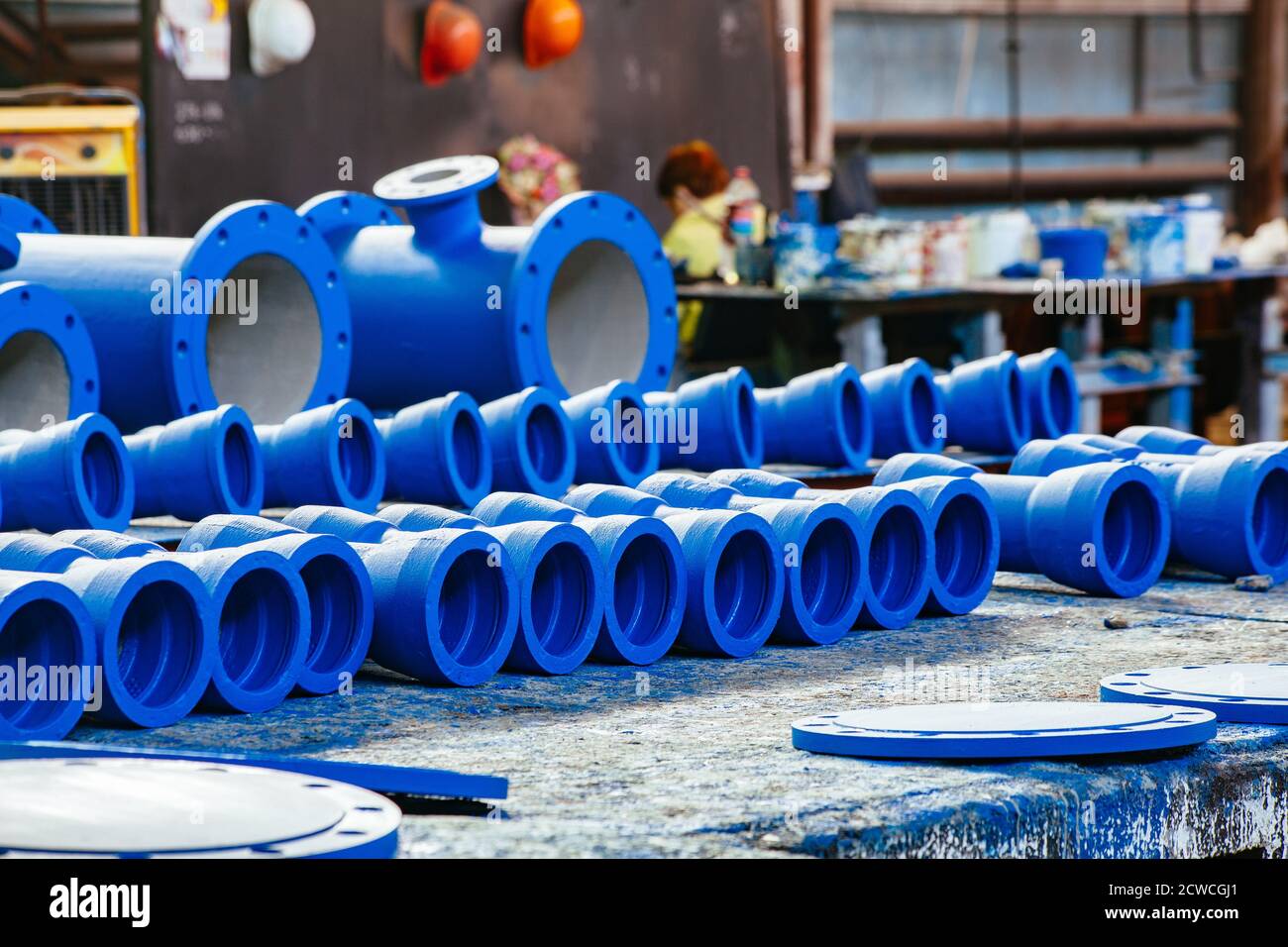 Cast metal blue pipe connection parts at workshop Stock Photo - Alamy