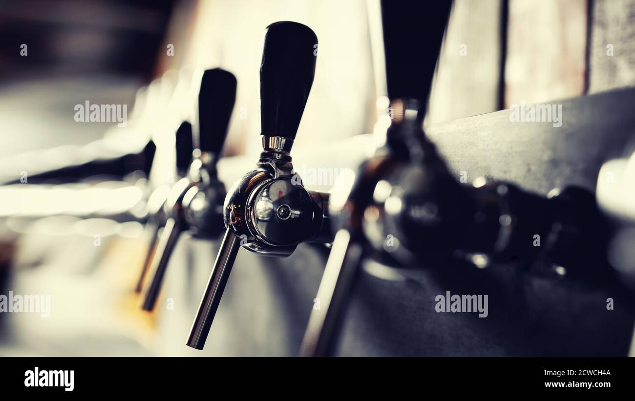 Beer craft steel taps raw in pub. Selective focus, light sun Stock ...