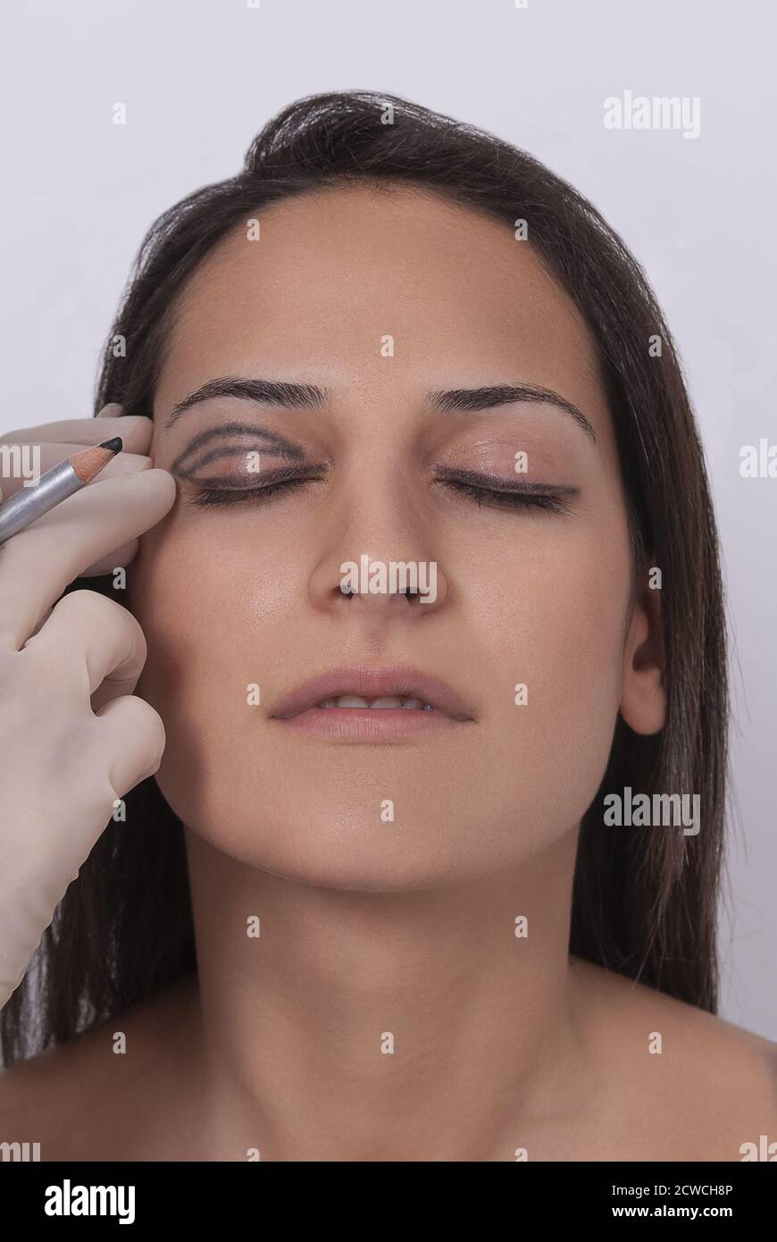 Vertical closeup shot of a woman preparing her face for a plastic ...