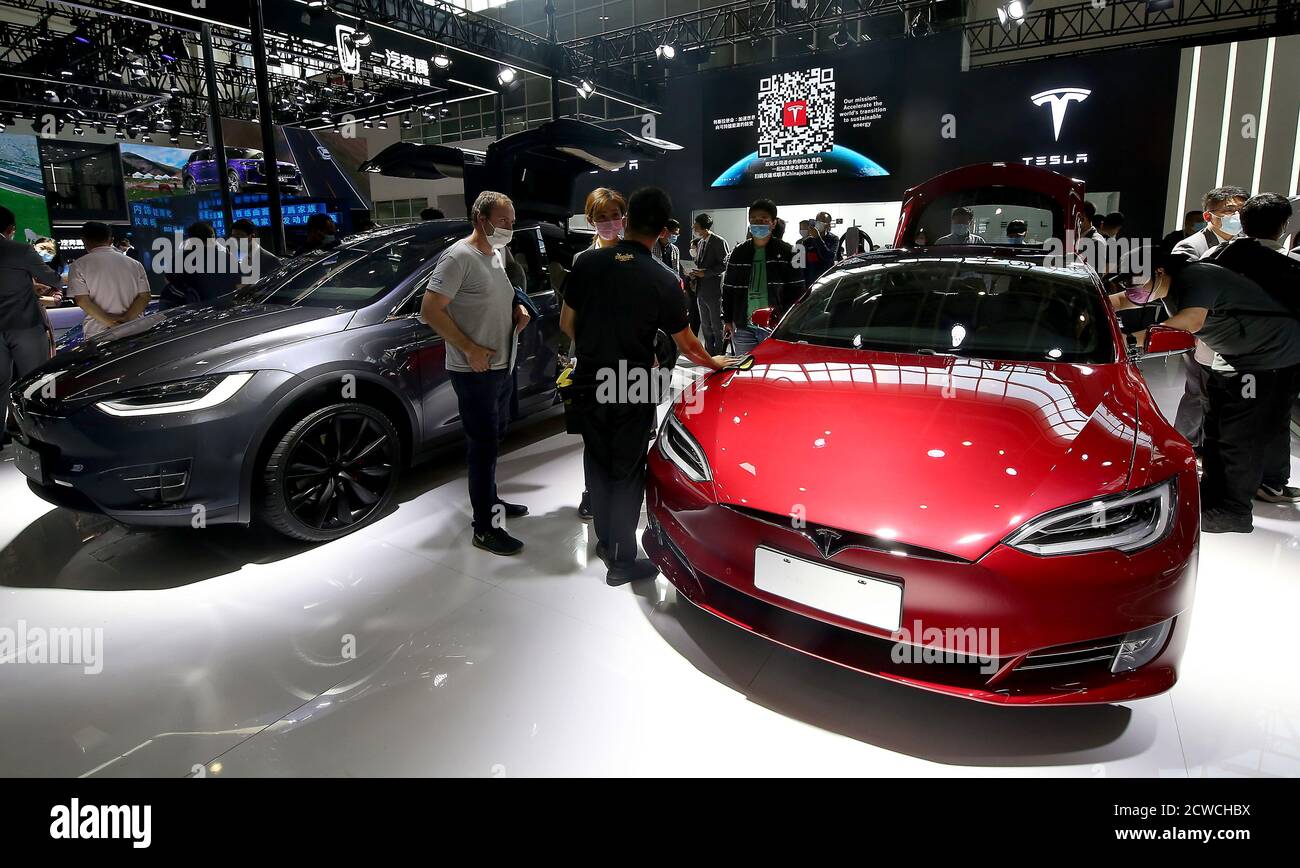 Beijing, China. 29th Sep, 2020. Chinese check out Tesla's Model X (L ...