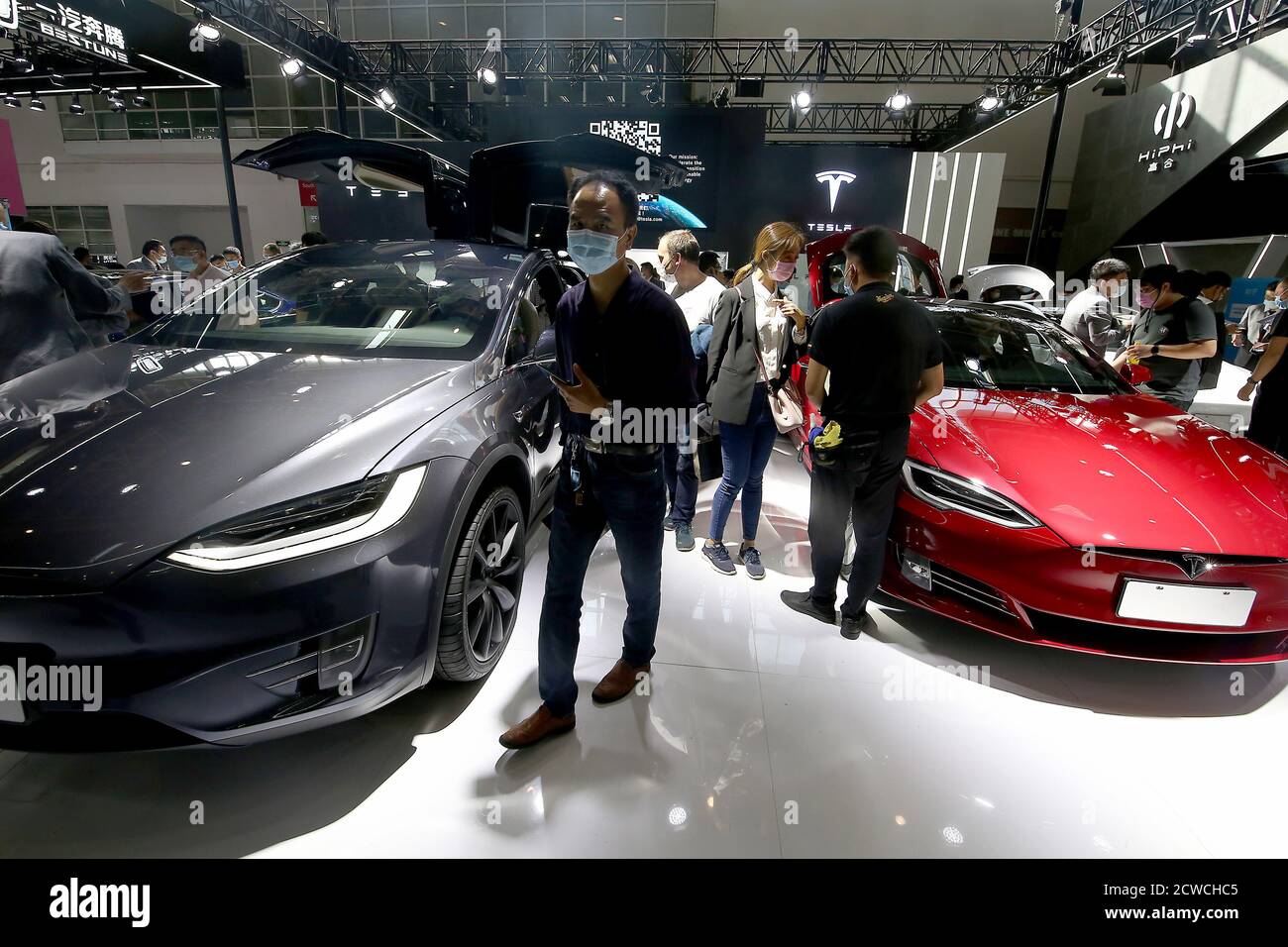 Beijing, China. 29th Sep, 2020. Chinese check out Tesla's Model X (L ...