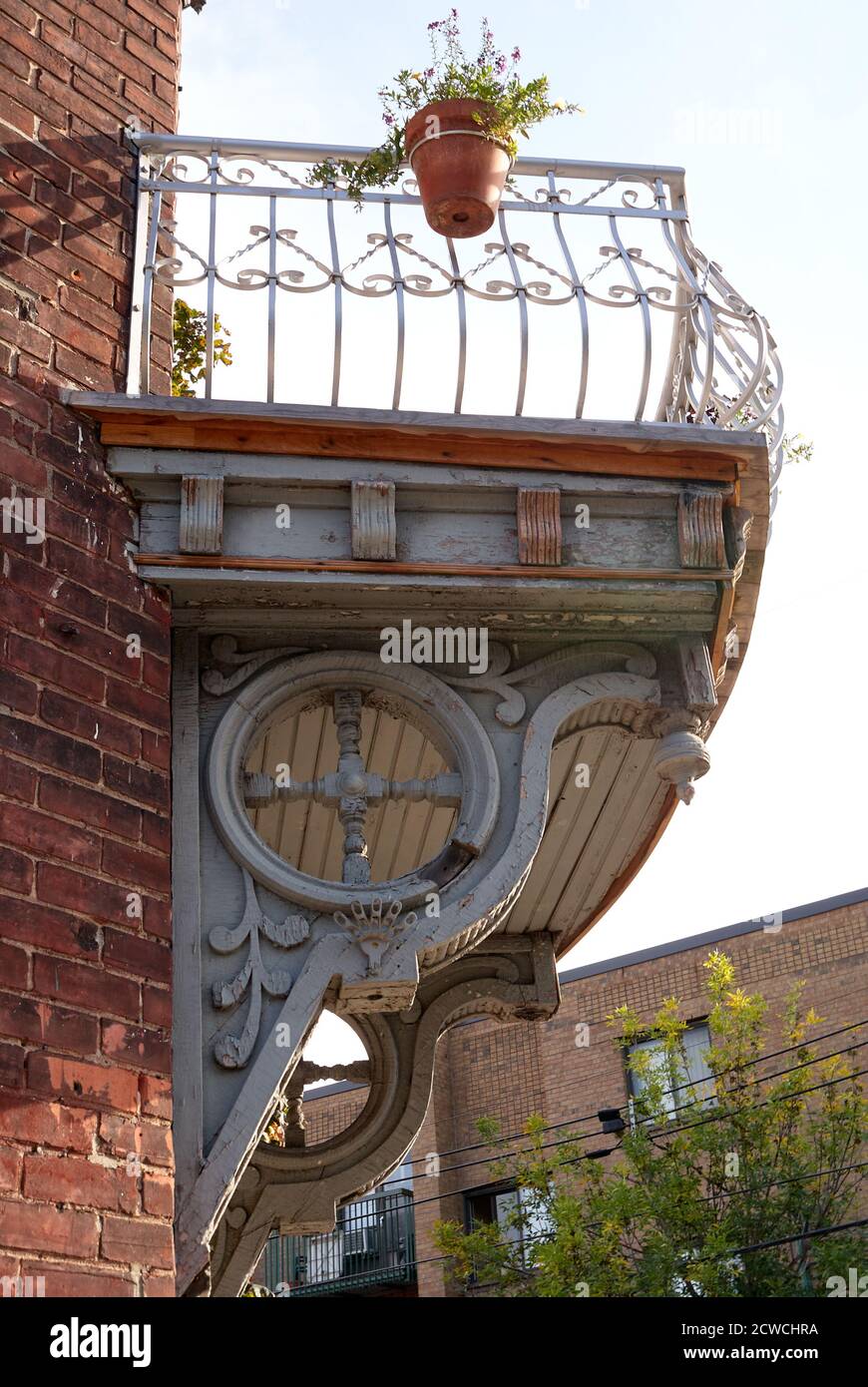 Ornate wooden bracket supporting a balcony of an old house in Montreal ...