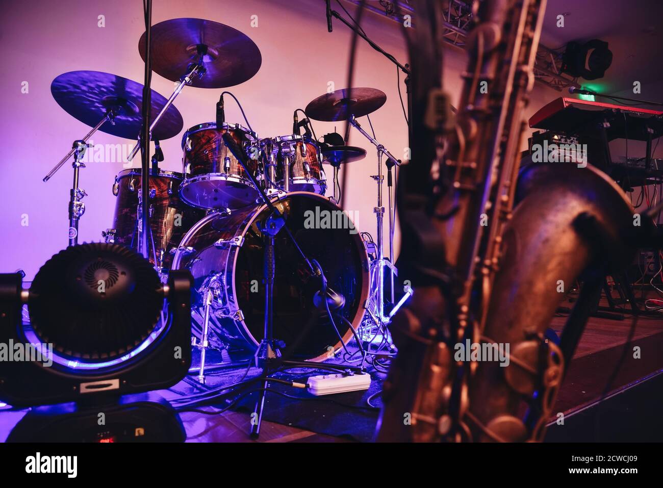 Concert scene with blue light, drum set Stock Photo - Alamy