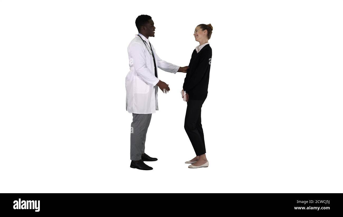 Doctor telling good news to a patient on white background Stock Photo ...