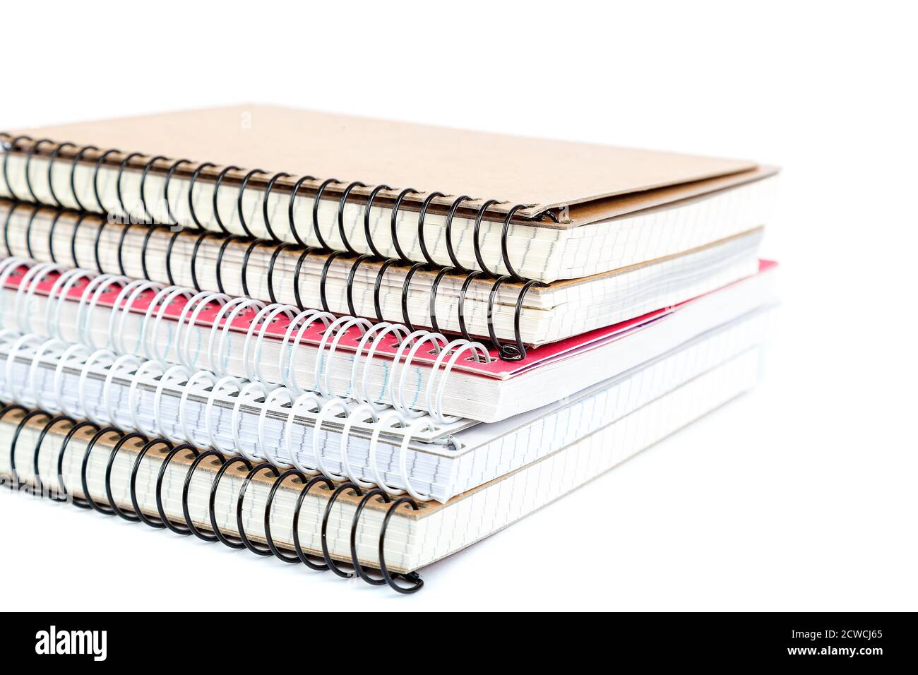 Stack spring notebooks isolated on white background Stock Photo - Alamy