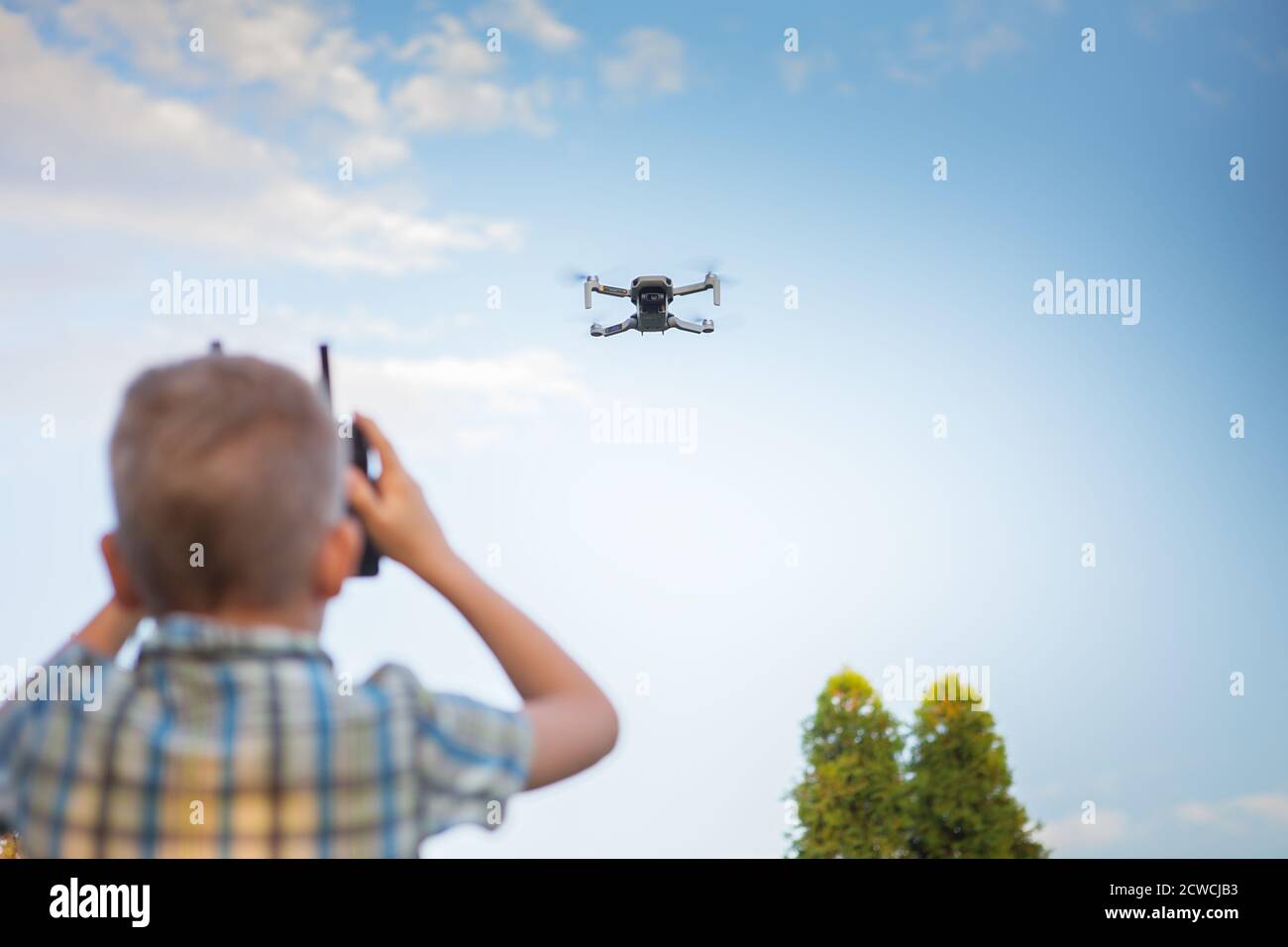 Kid flying drone. Boy operate drones. Child Operating Quadcopter ...