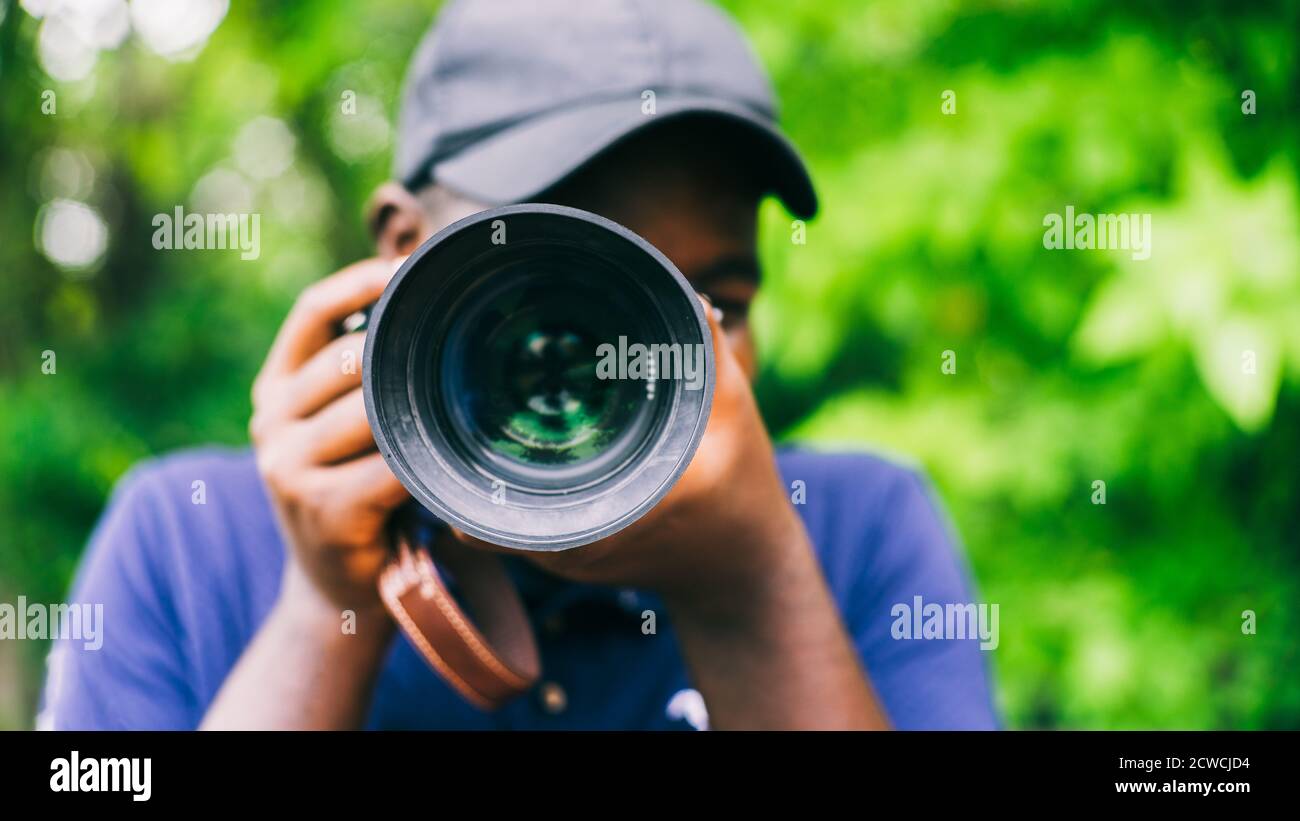 African man photographer taking a camera.16:9 style Stock Photo - Alamy