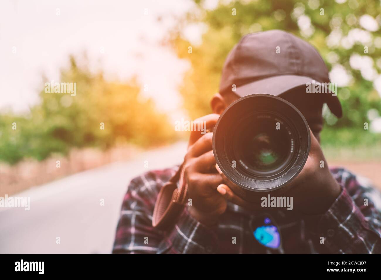 African man photographer taking a camera Stock Photo - Alamy