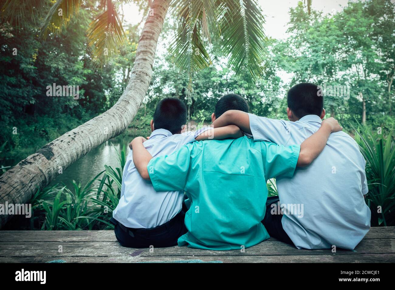 Back view of three students friends hugging with love.Concept of best ...