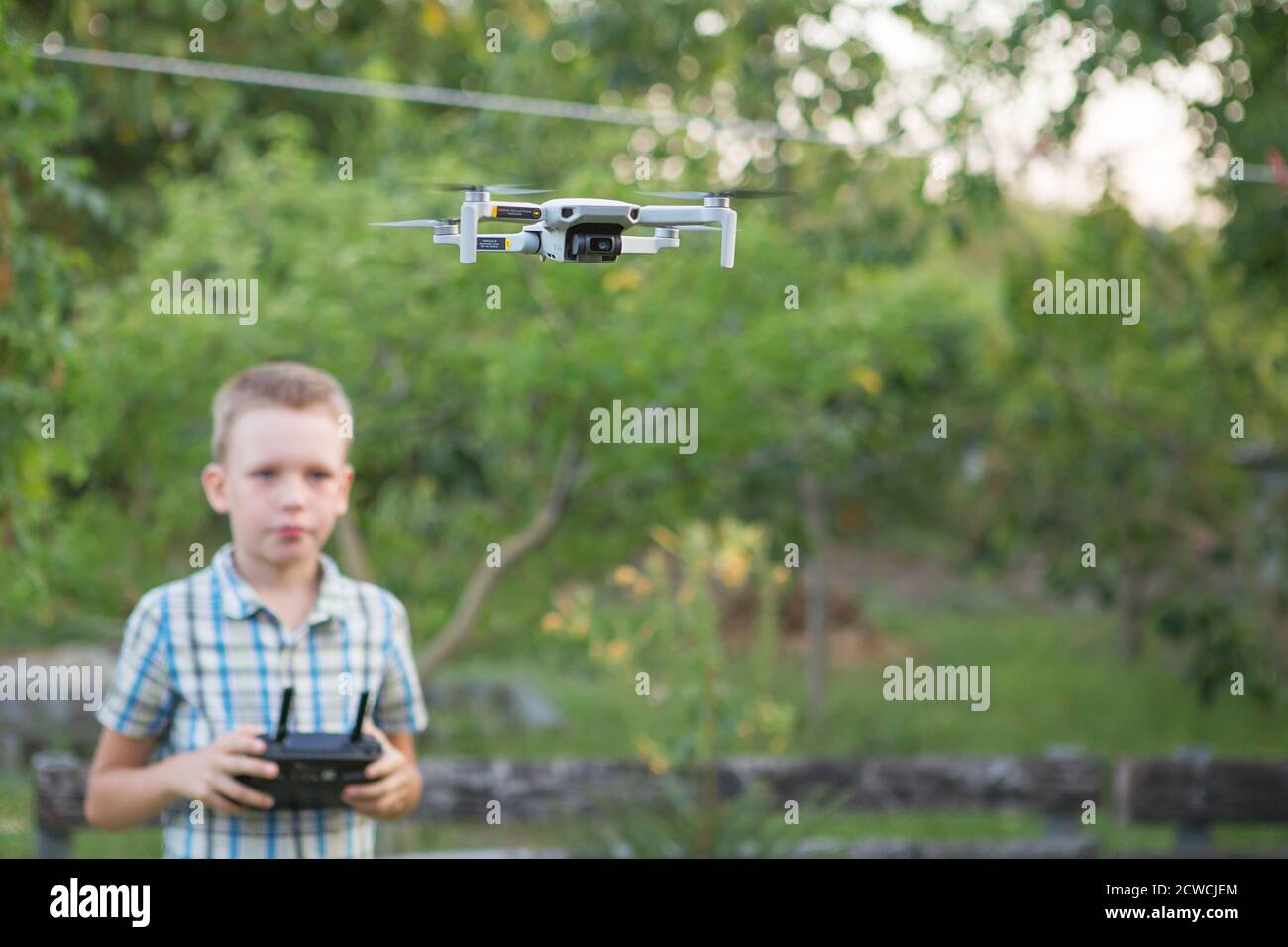 Kid flying drone. Boy operate drones. Child Operating Quadcopter ...