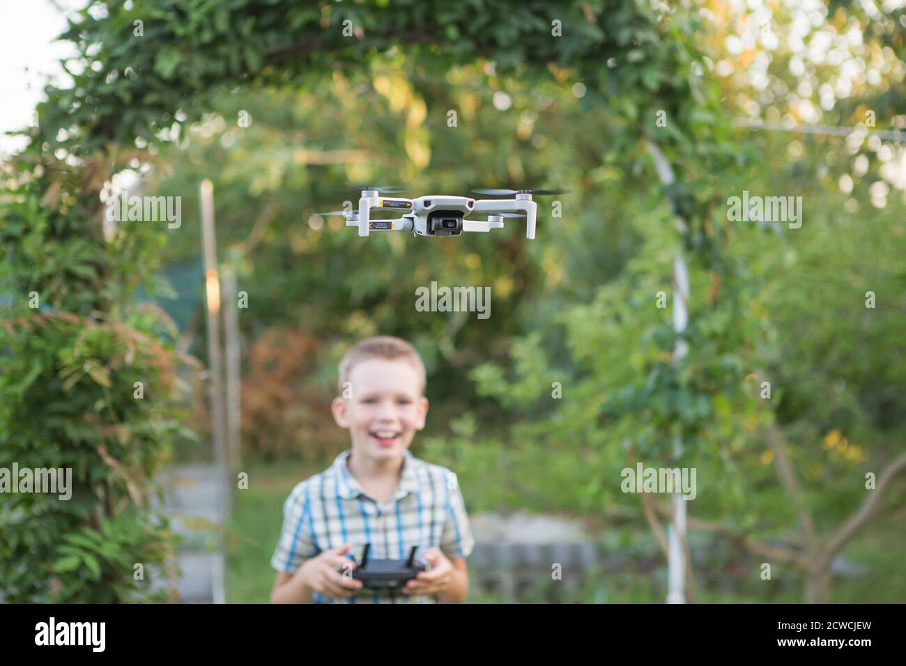 Kid flying drone. Boy operate drones. Child Operating Quadcopter ...