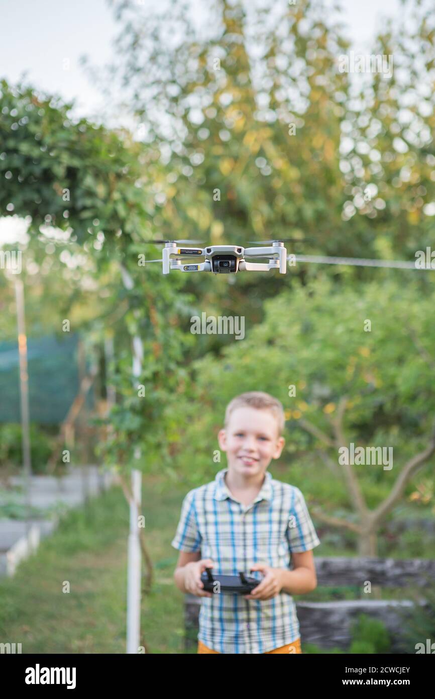 Kid flying drone. Boy operate drones. Child Operating Quadcopter ...
