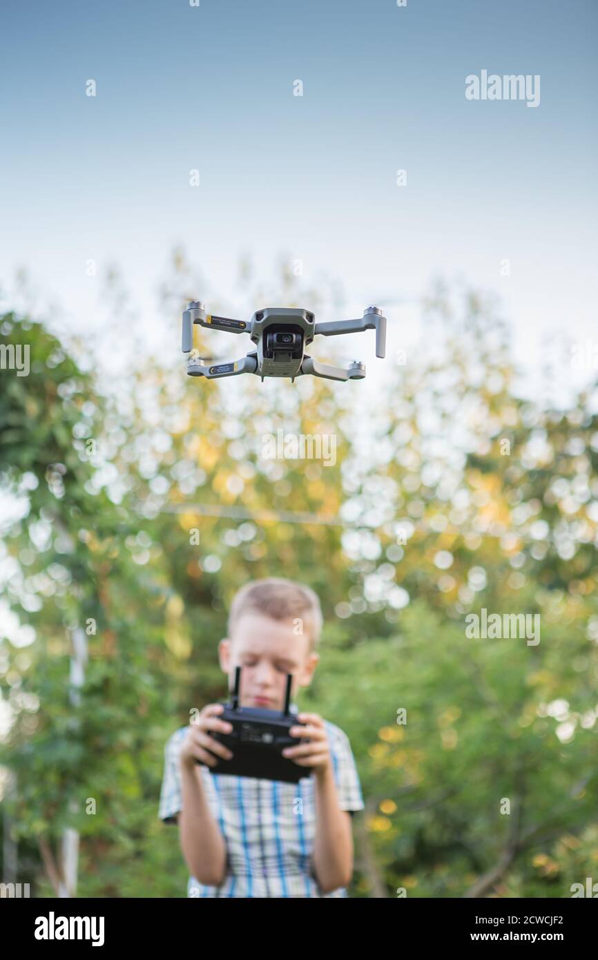Kid flying drone. Boy operate drones. Child Operating Quadcopter ...