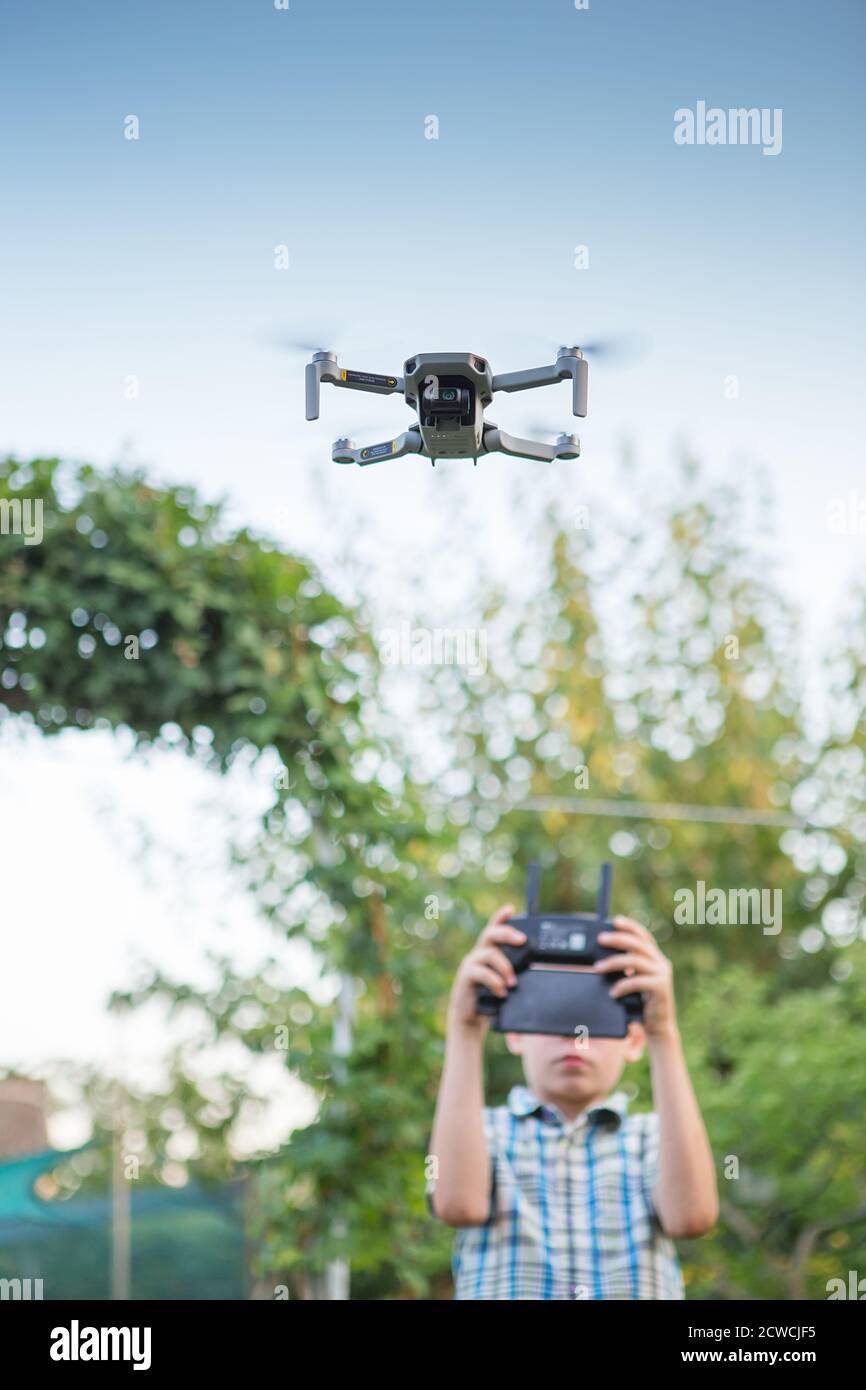 Kid flying drone. Boy operate drones. Child Operating Quadcopter ...