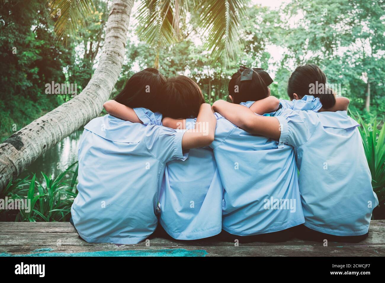 Back view of three students friends hugging with love.Concept of best ...