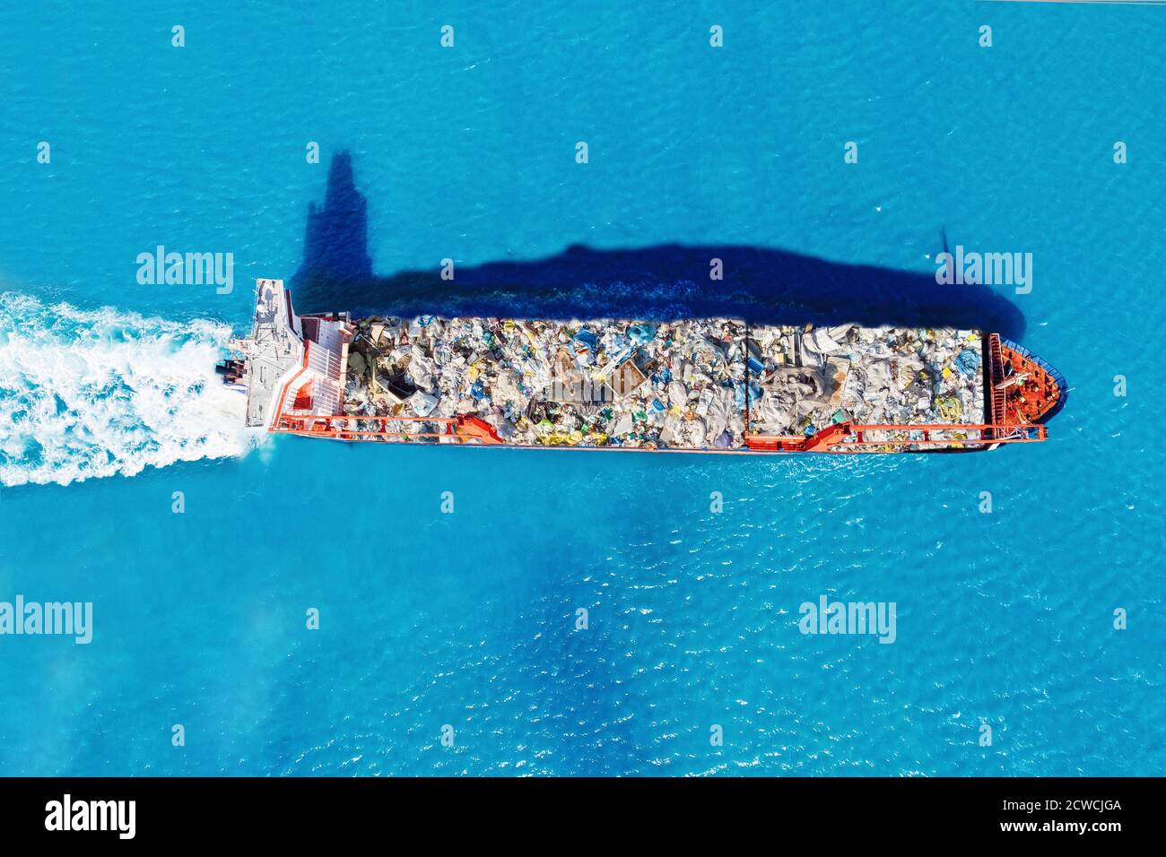 Cargo ship transports containers of garbage for recycling factory ...