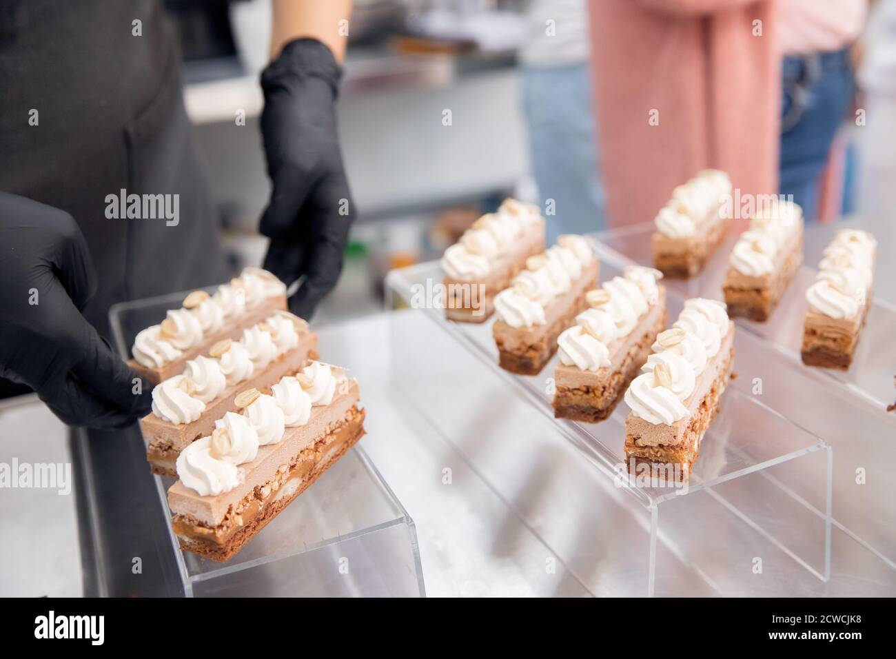 Decor of cakes with chocolate and nuts, close-up of serving sweets in ...
