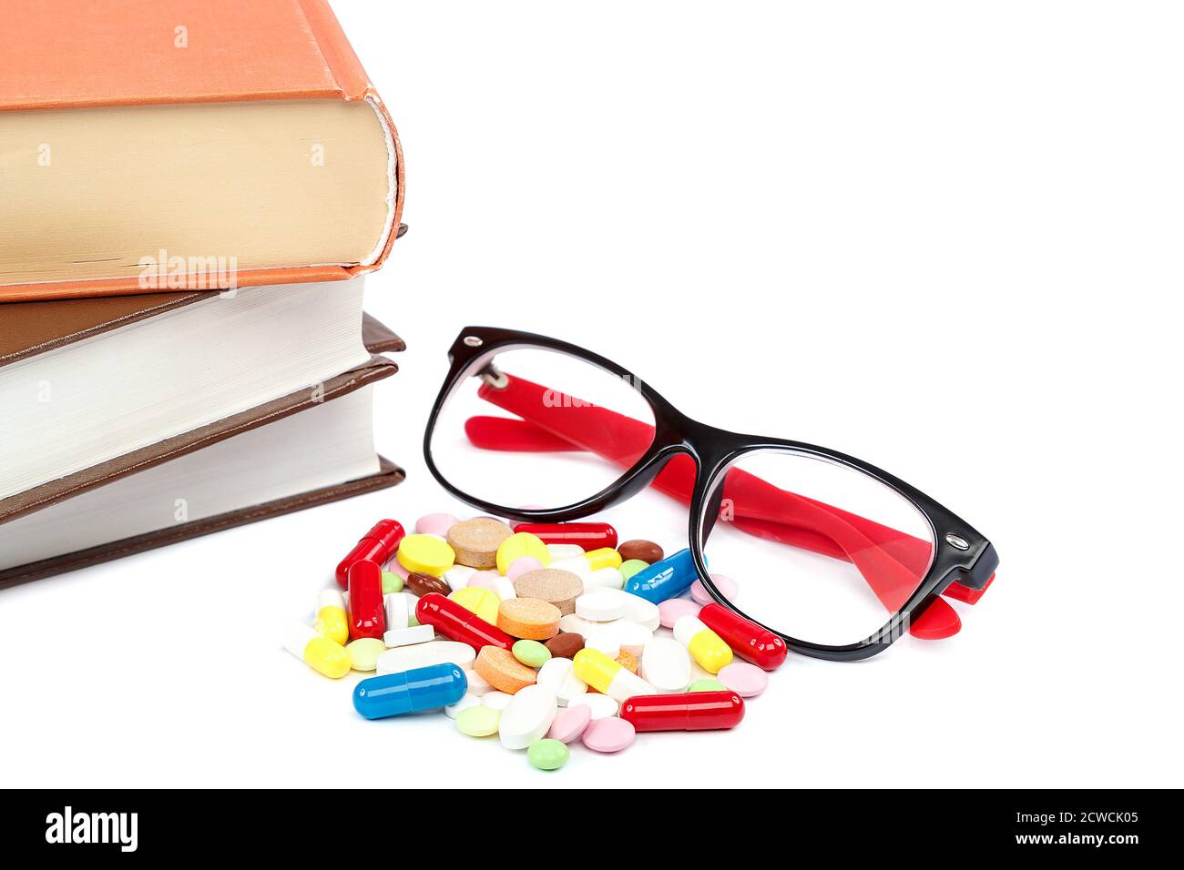 Stack of books and pills, capsules isolated on white background ...