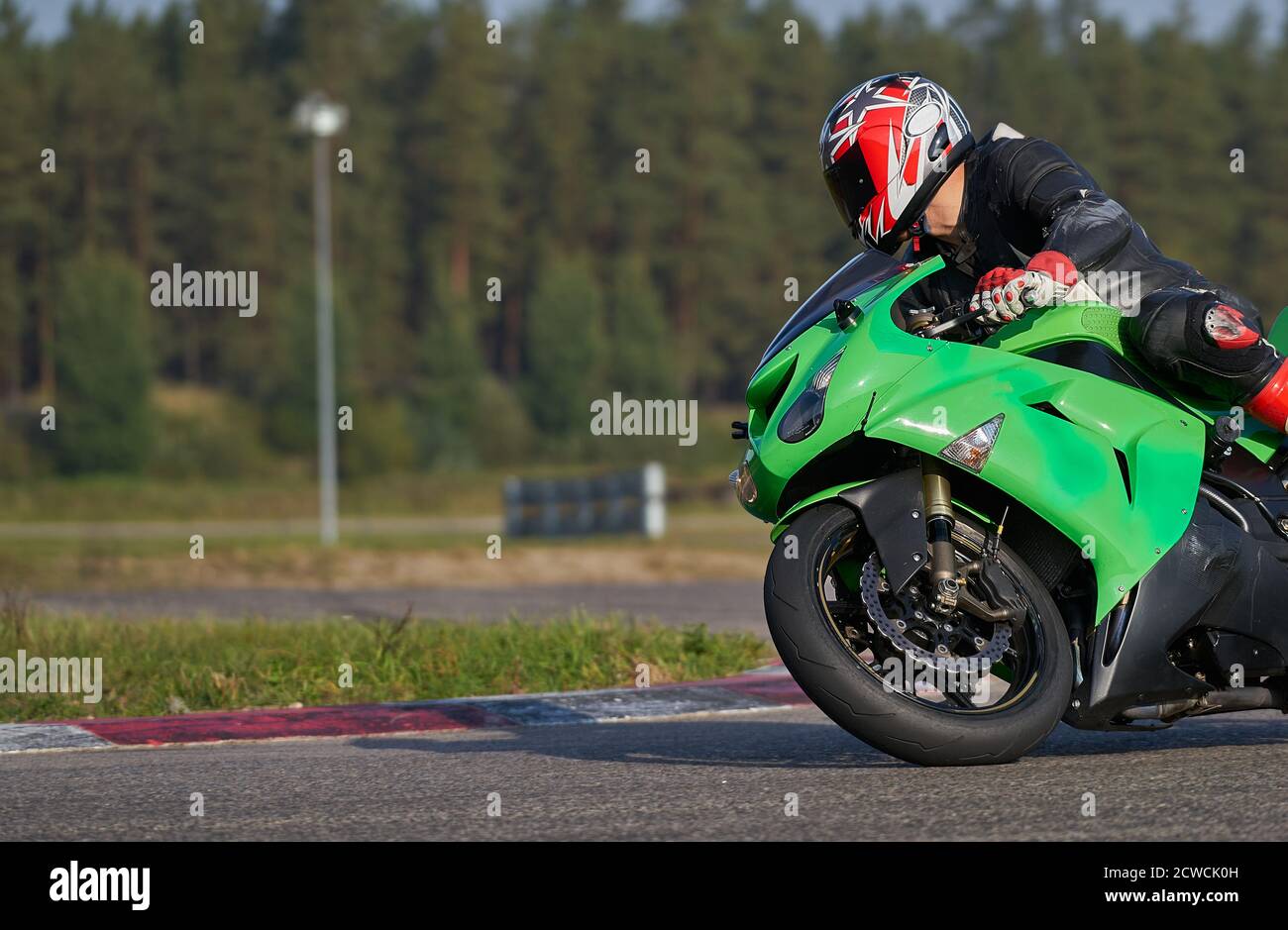 Handsome motorcyclist riding his super sport motorcycle Stock Photo - Alamy