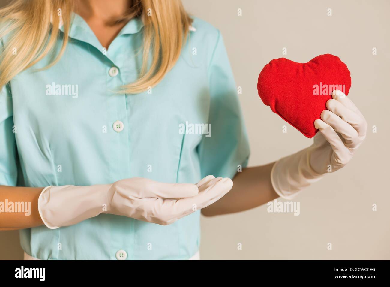 Image of medical nurse holding red heart Stock Photo - Alamy