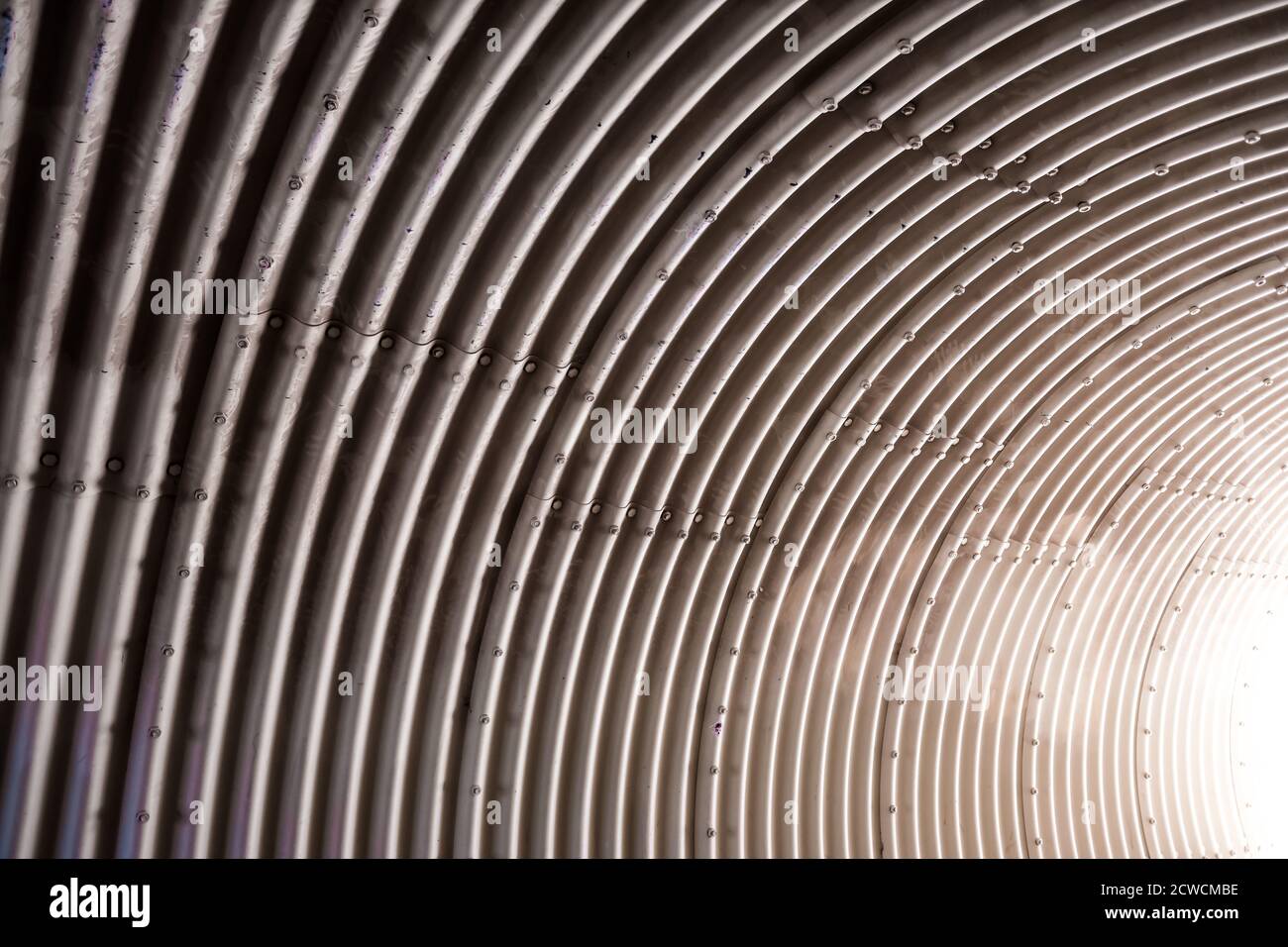 Interior of a tunnel formed with a large metal tube, construction ...