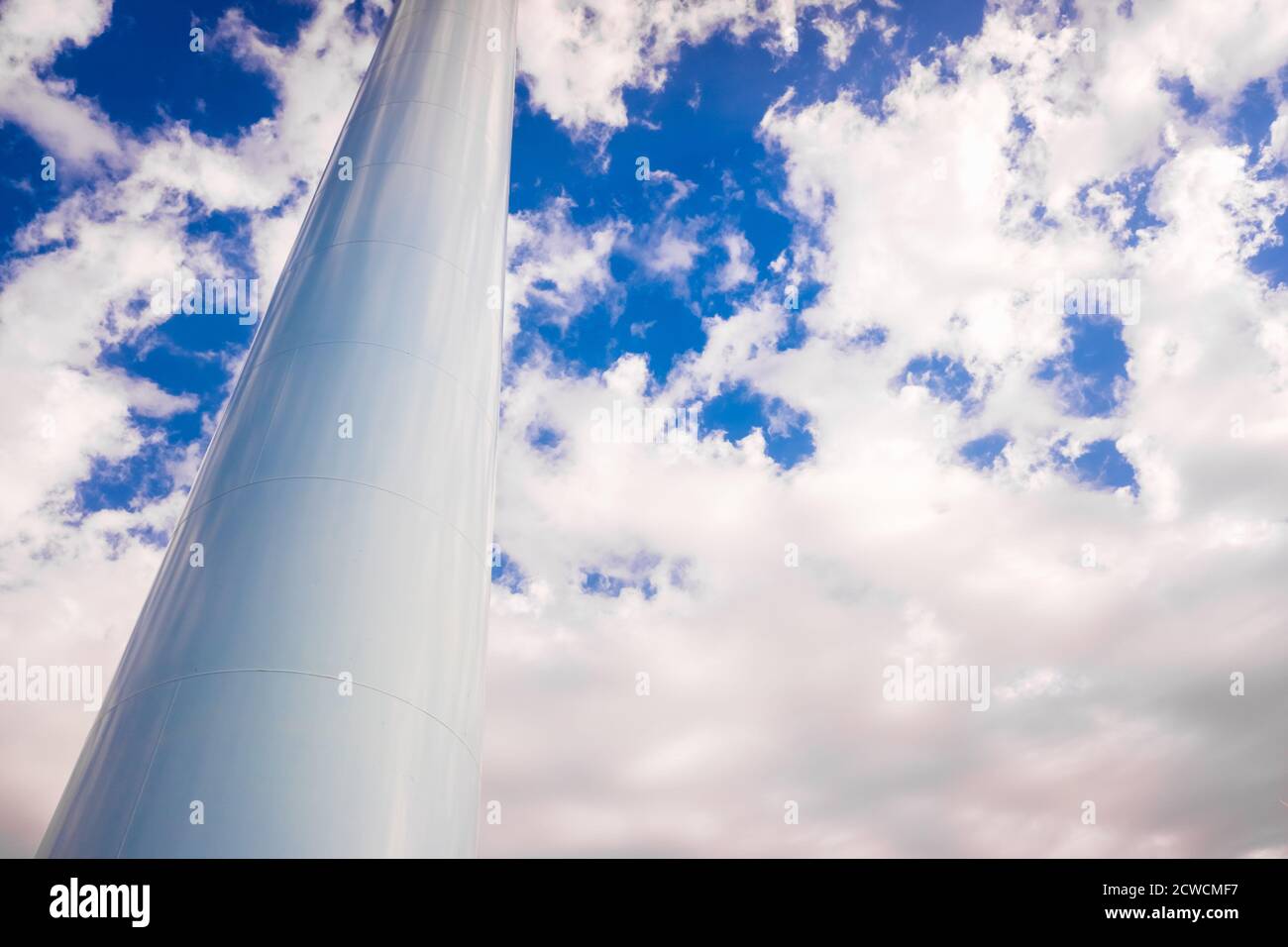 Thick metallic white pipe in vertical position as base of a tower ...