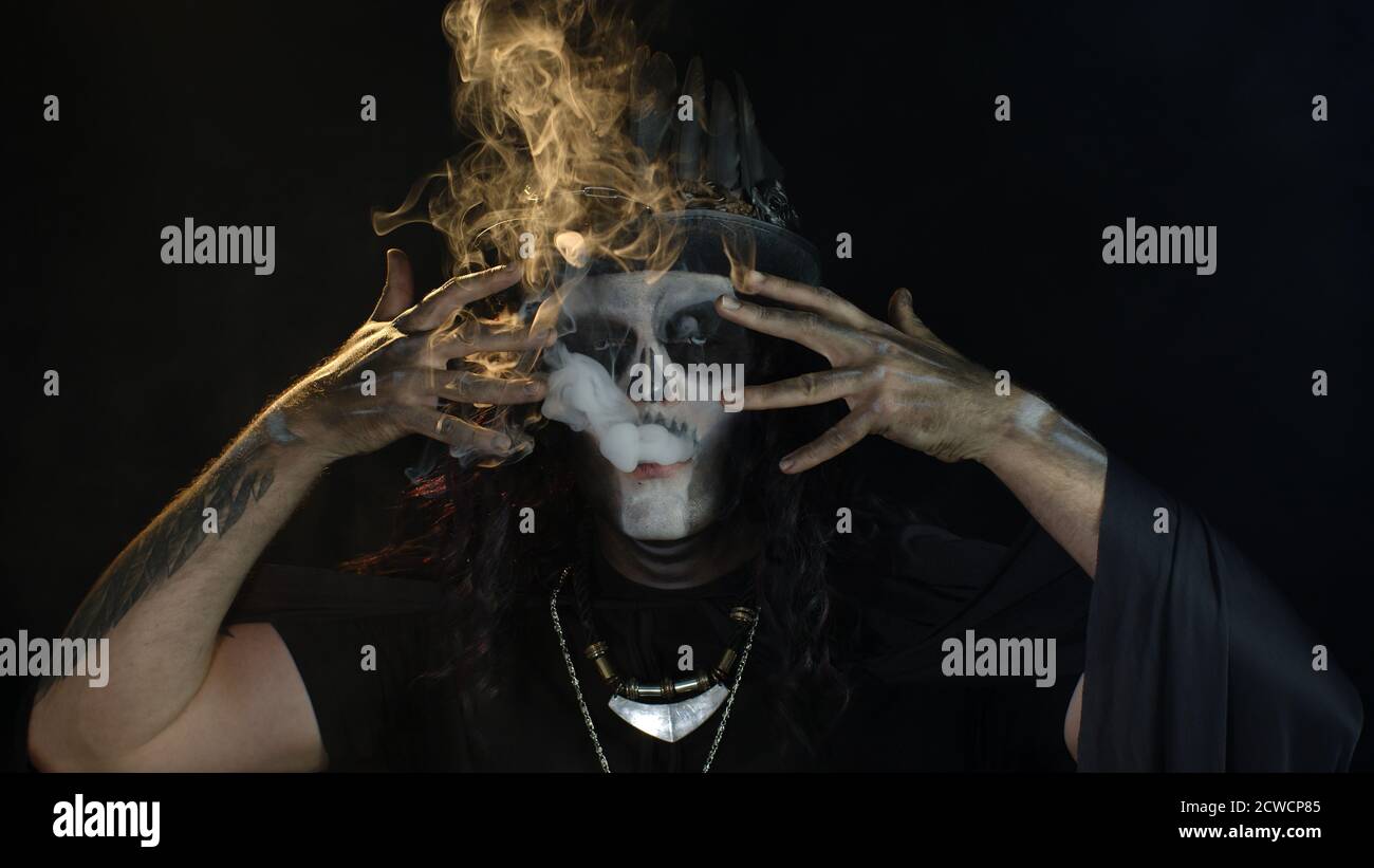 Sinister man with horrible Halloween skeleton makeup in costume with ...