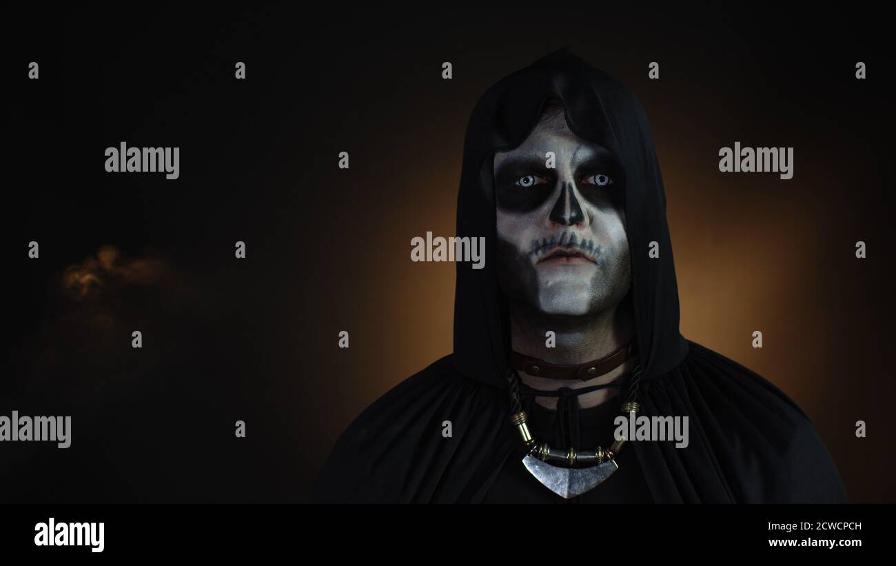 Sinister man with horrible Halloween skeleton makeup in costume with ...
