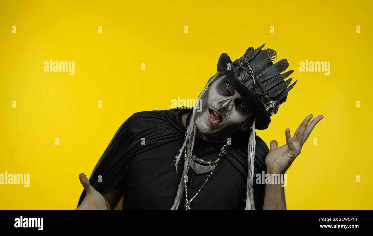 Sinister, crazy man with skeleton makeup in top-hat. Guy making angry ...