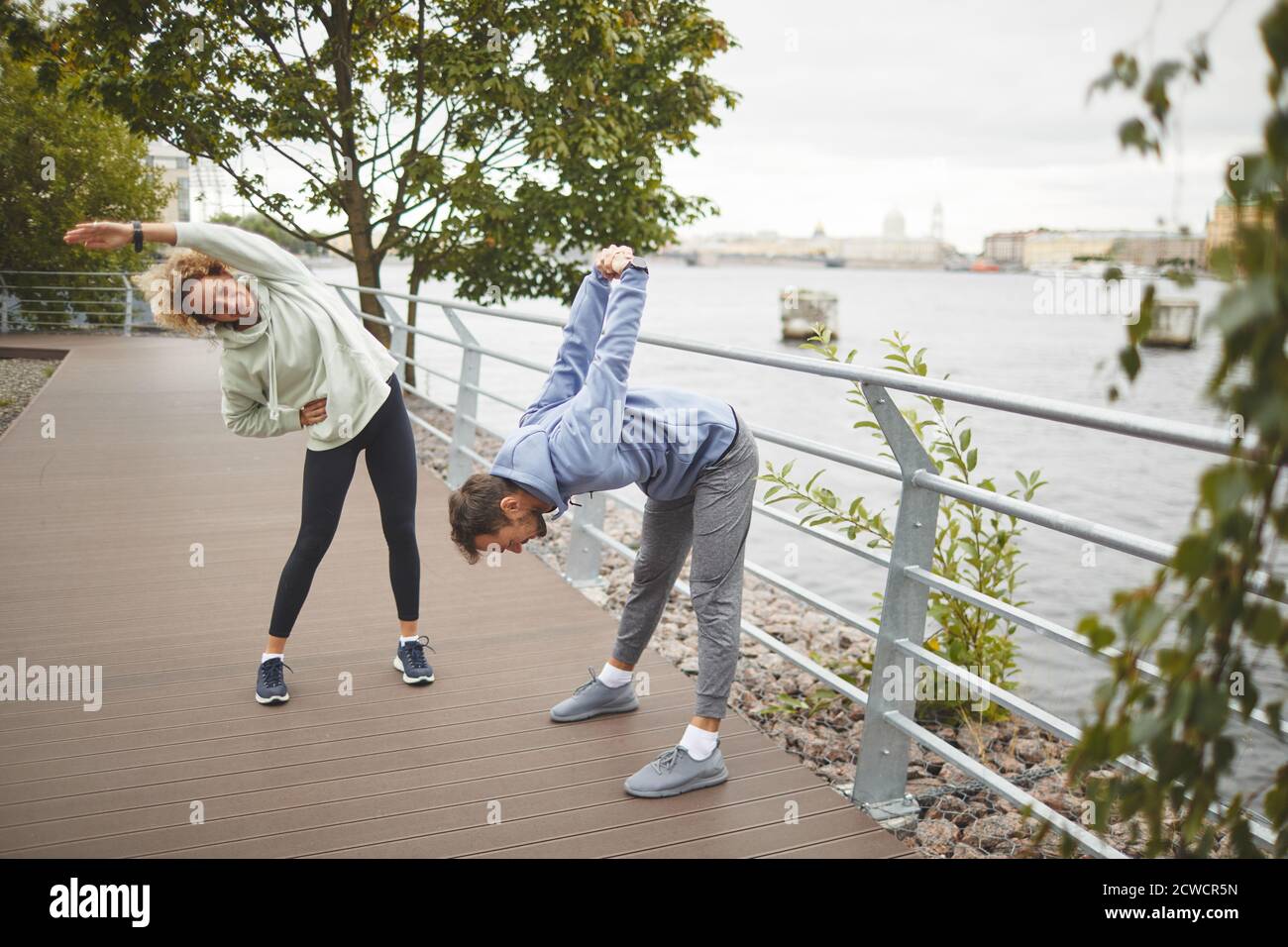 Young people doing stretching exercises during sports training in the ...