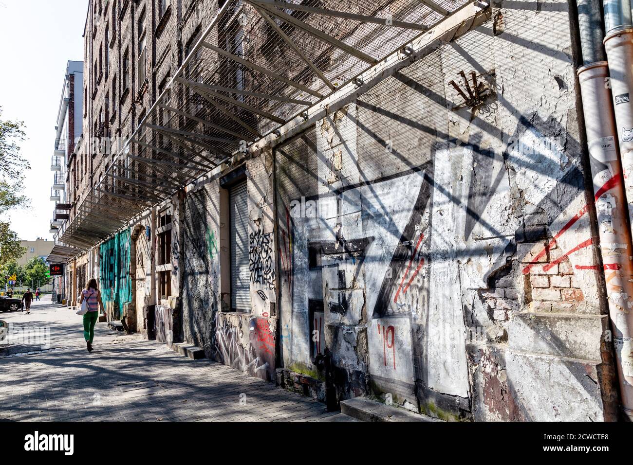 Run down building with graffiti on Wileńska Street in Praga district of ...