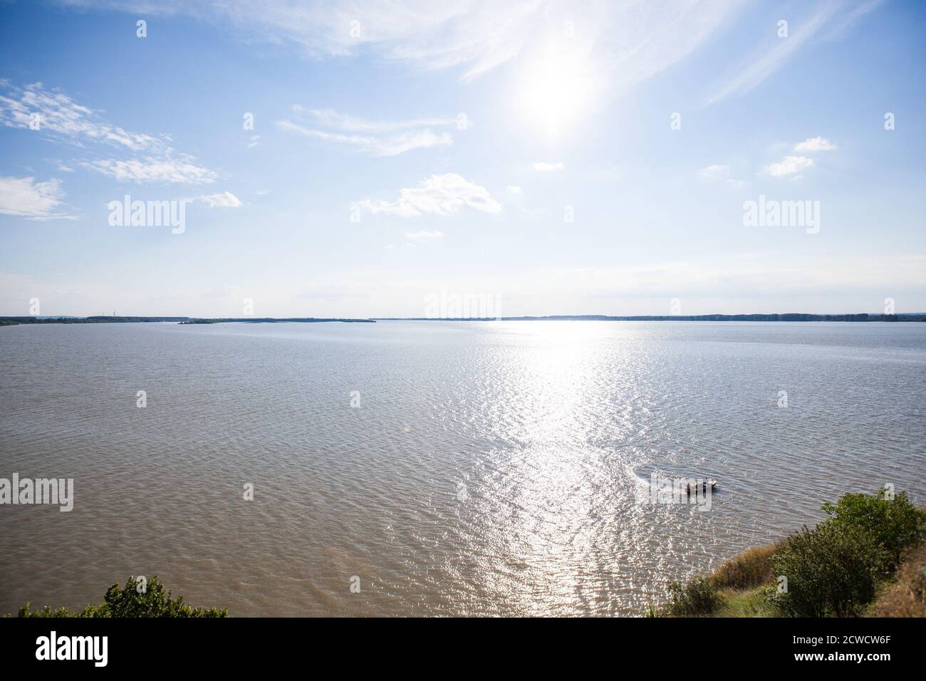 Beautiful sunset over river water with boat , sunlight reflection ...