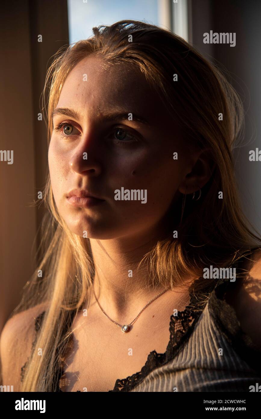 Portrait of a beautiful girl by the window Stock Photo - Alamy